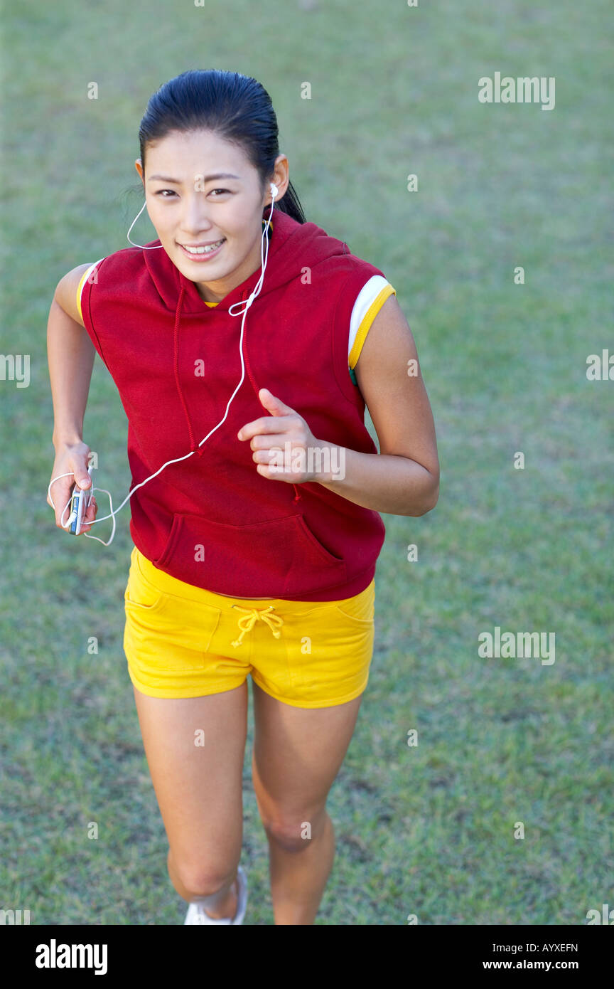 running woman with ear phone Stock Photo - Alamy