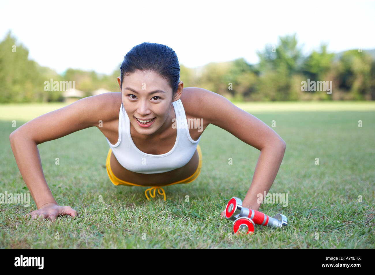 excercising woman behind the dumbbell Stock Photo - Alamy