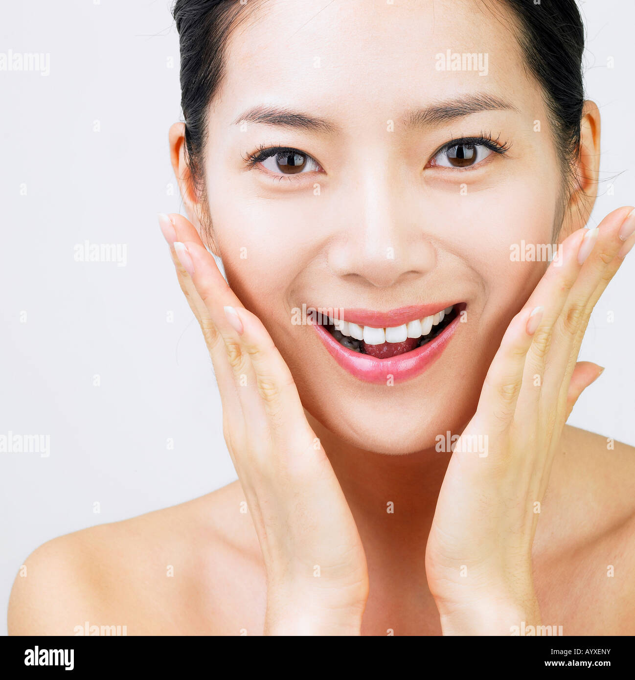 a woman's face smiling put hands on face Stock Photo - Alamy