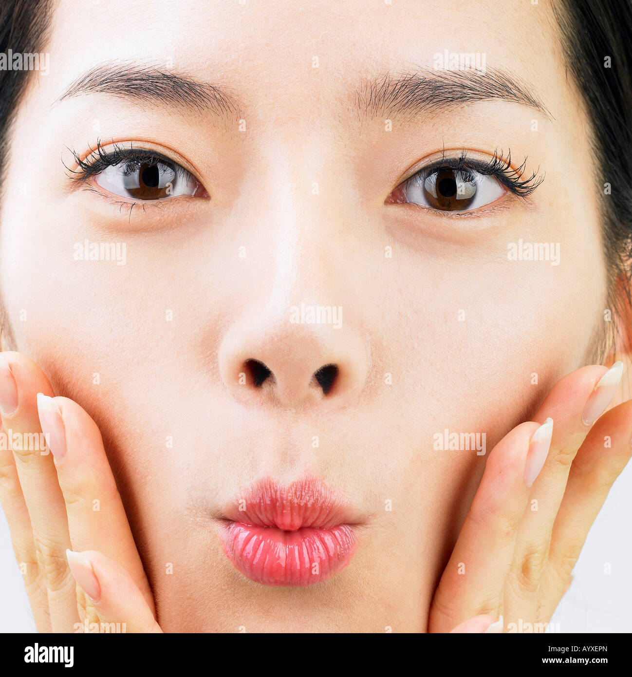 a woman's face put with hands Stock Photo - Alamy