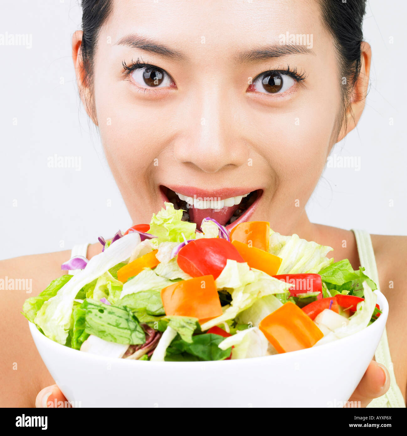 a woman holding the vessel contained with vegetable salad Stock Photo ...