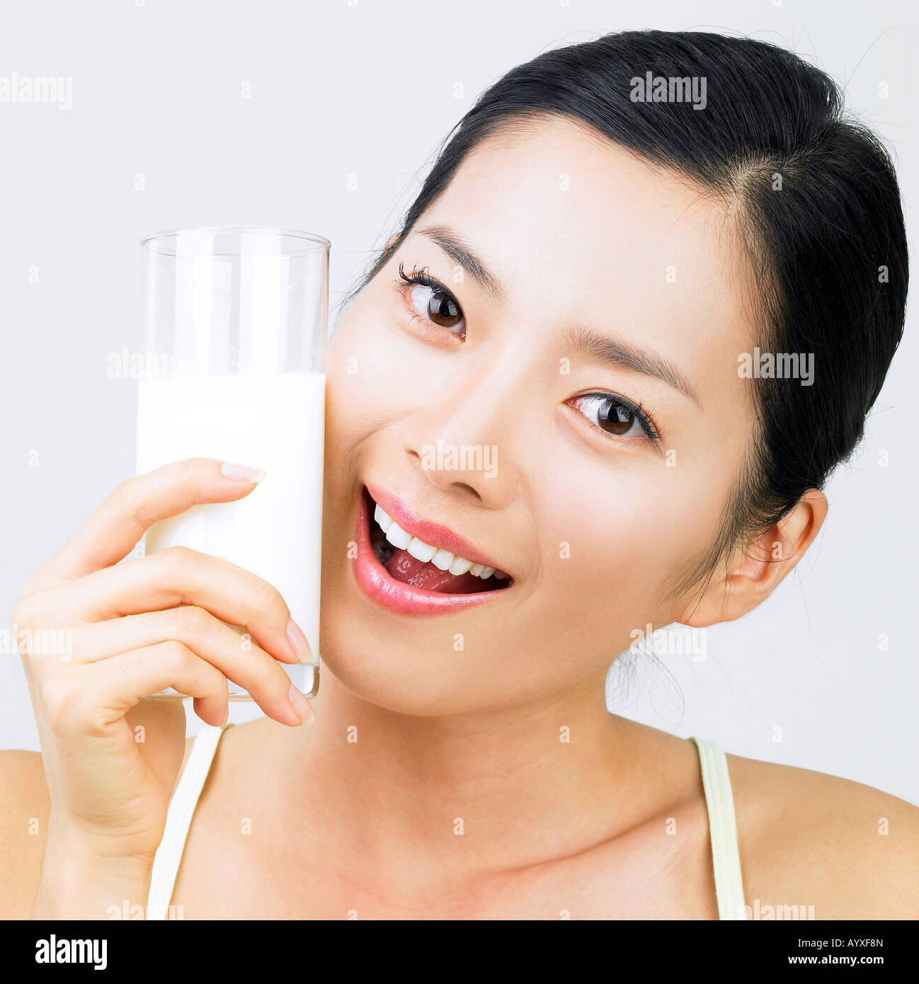 a woman face and milk in cup Stock Photo - Alamy