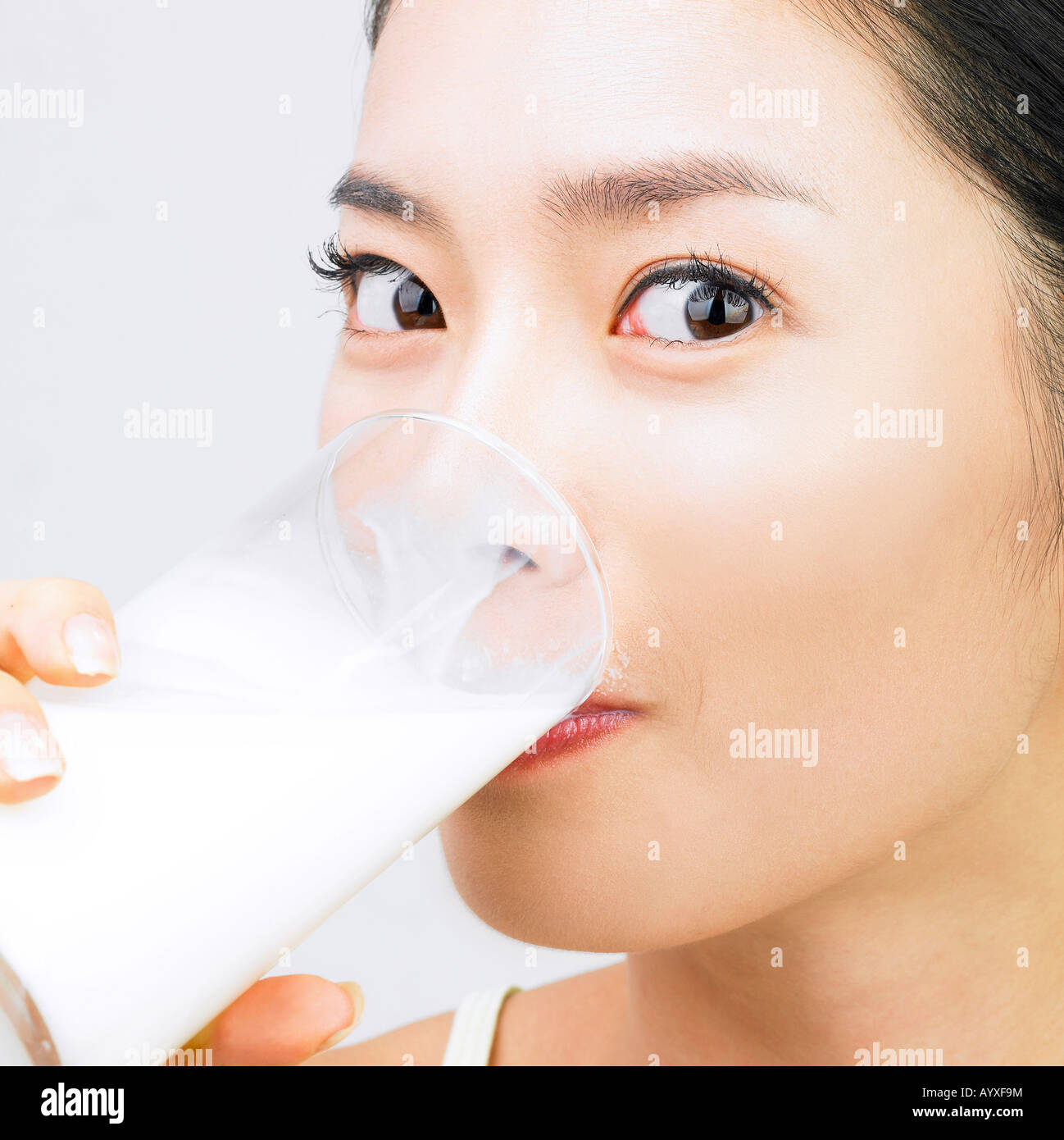 a woman's face drinking milk Stock Photo - Alamy