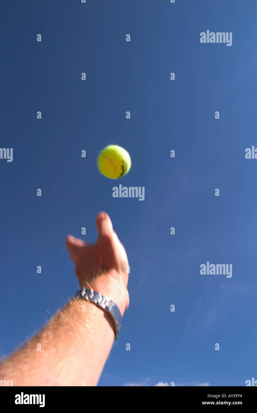 Arm of tennis player throwing ball up to serve Stock Photo - Alamy