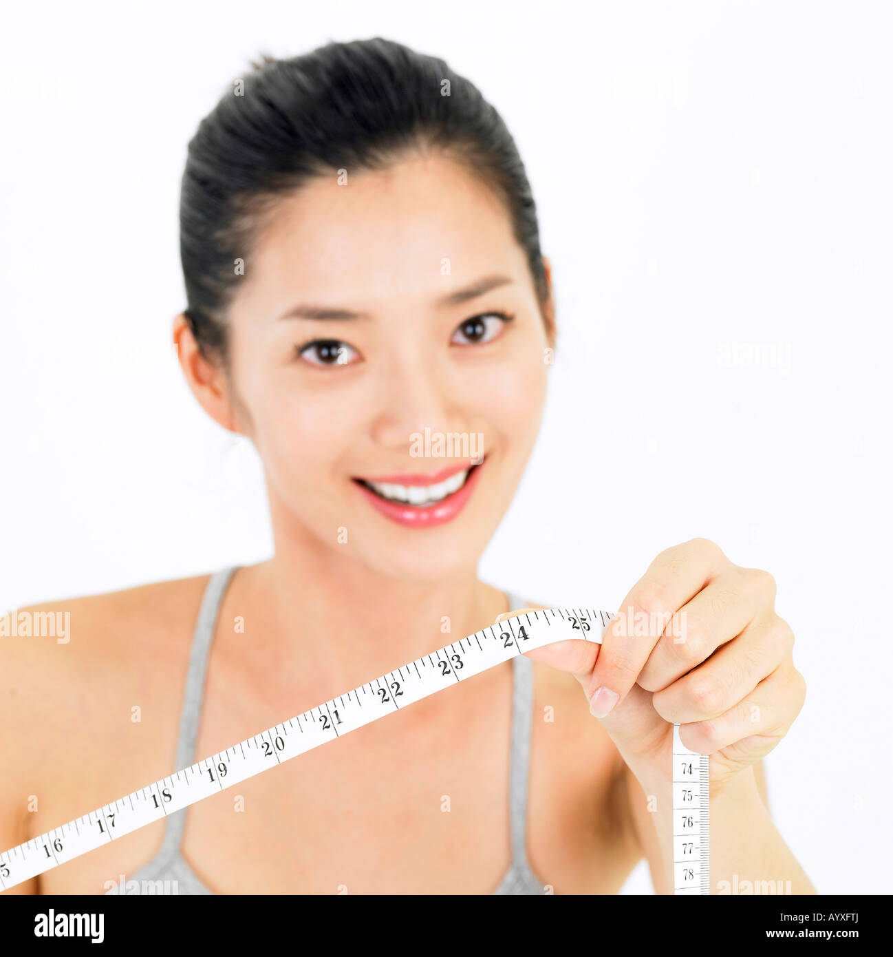 a woman holding a measuring tape Stock Photo - Alamy