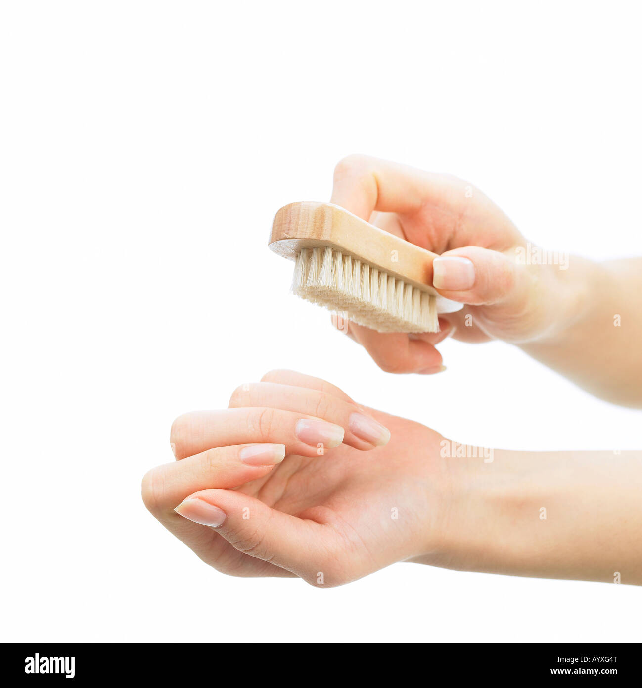 a hand with holding a brush and handling a fingernail with care Stock ...