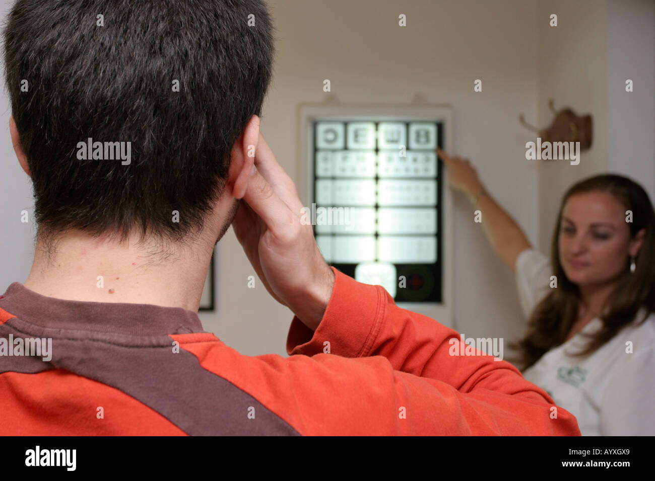 A female ophthalmologist doctor doing a visual acuity test to a patient ...