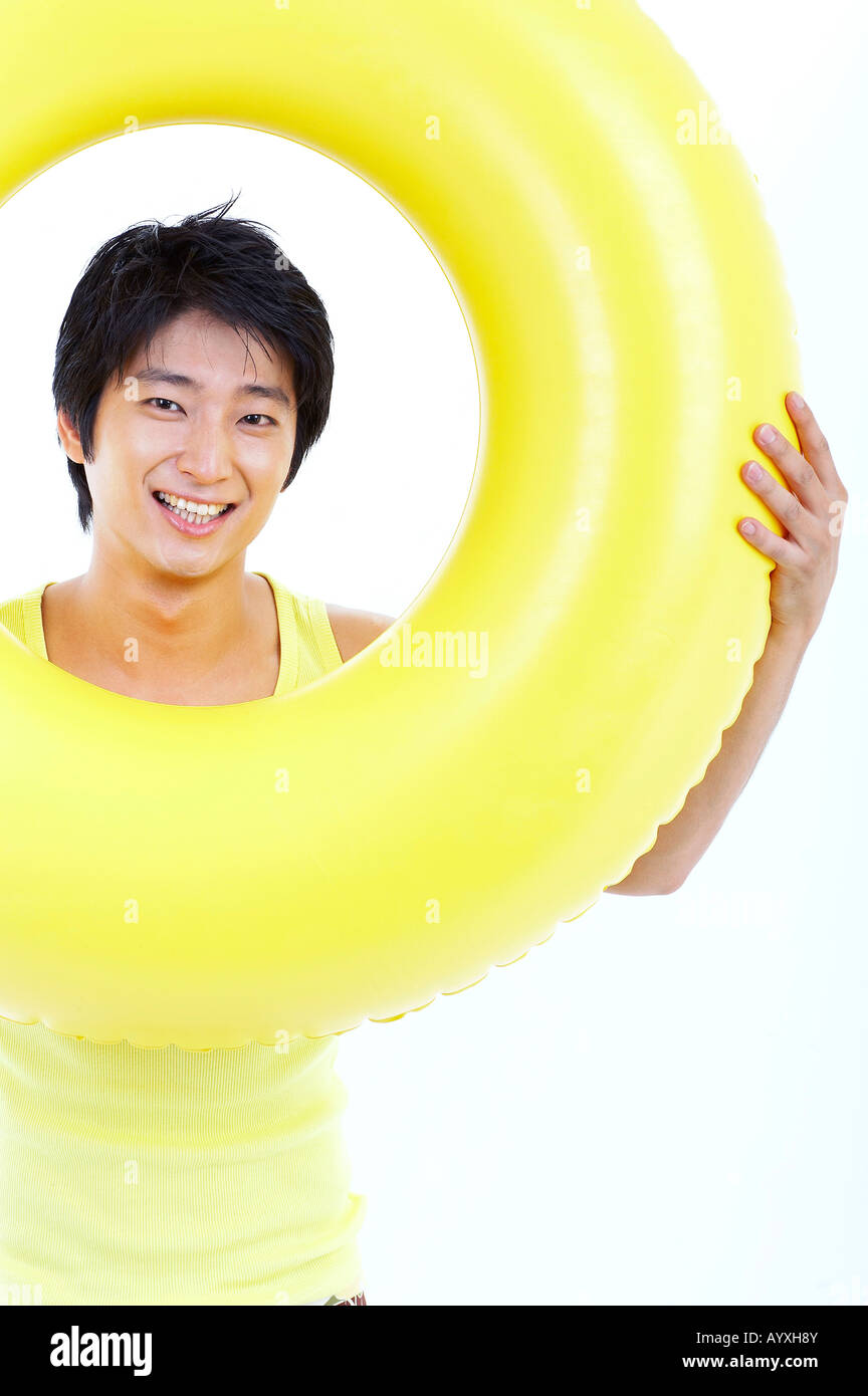 a man smiling among a yellow tube Stock Photo - Alamy