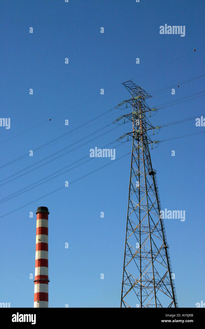 Electricity pylon and a factory chimney Stock Photo - Alamy