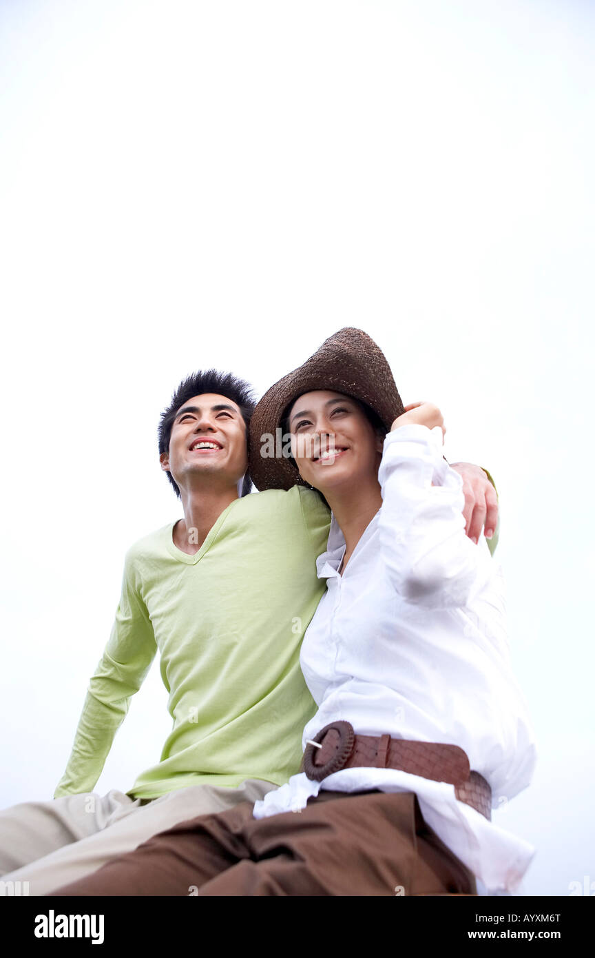 a couple looking at the sky with putting arms around each other´s ...