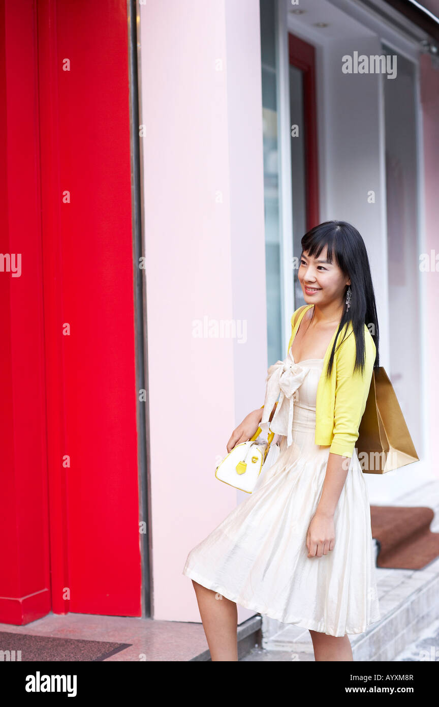 a woman smiling with looking at the showwindow Stock Photo - Alamy
