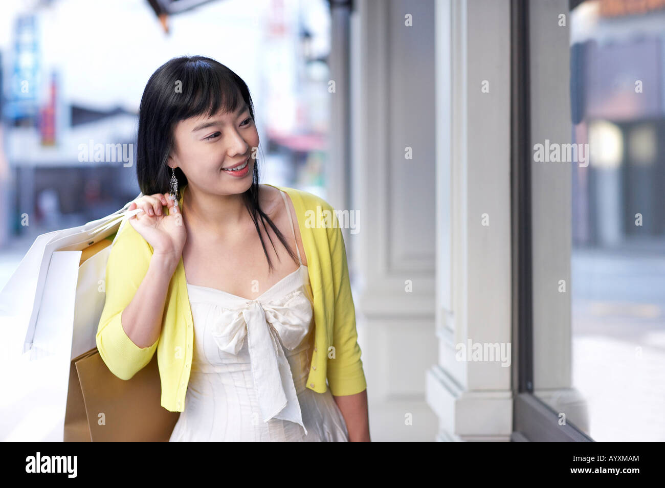 a woman seeing showwindow with holding a shopping bag Stock Photo - Alamy