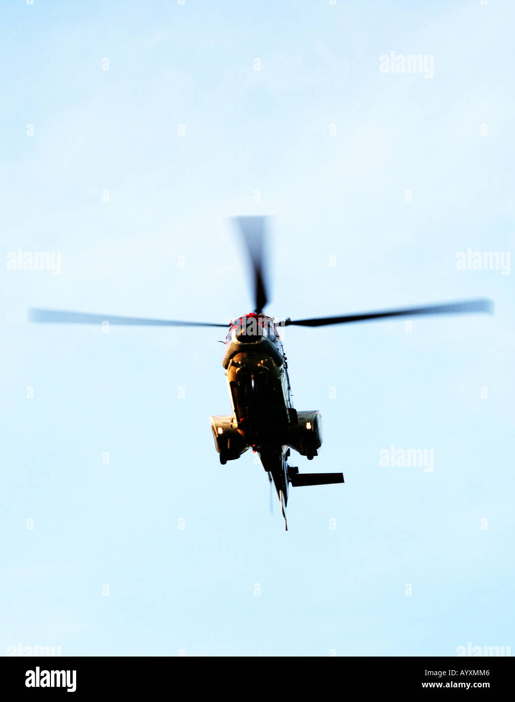 A portrait format image of a helicopter taken from underneath ...