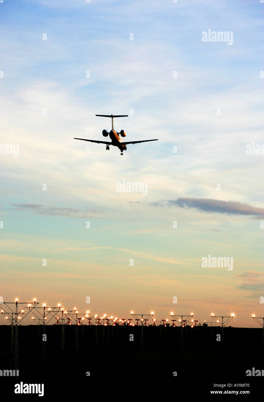 A portrait format image of a commercial passenger aircraft on final ...