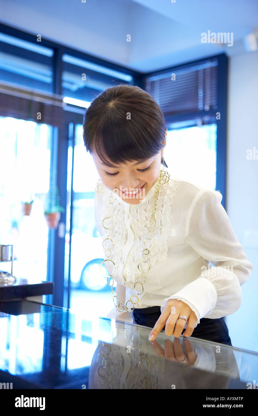 a woman browsing items on display Stock Photo - Alamy