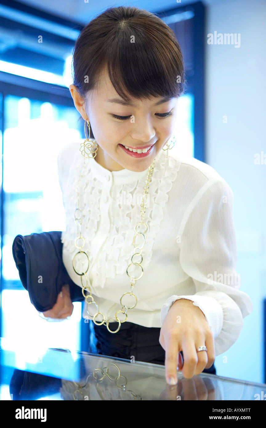 a woman browsing items on display Stock Photo - Alamy