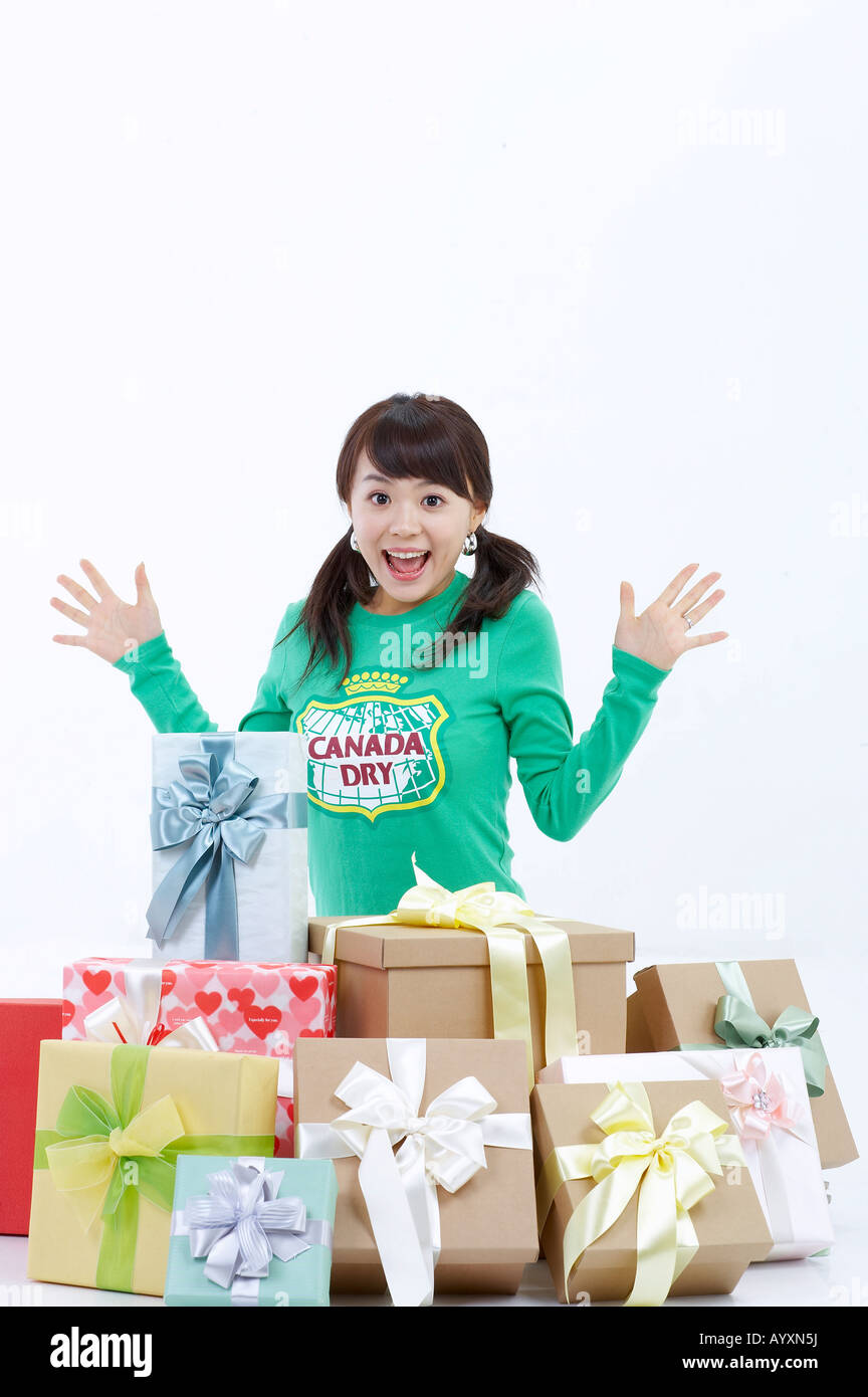 a woman being pleased looking at stack of gift case Stock Photo - Alamy