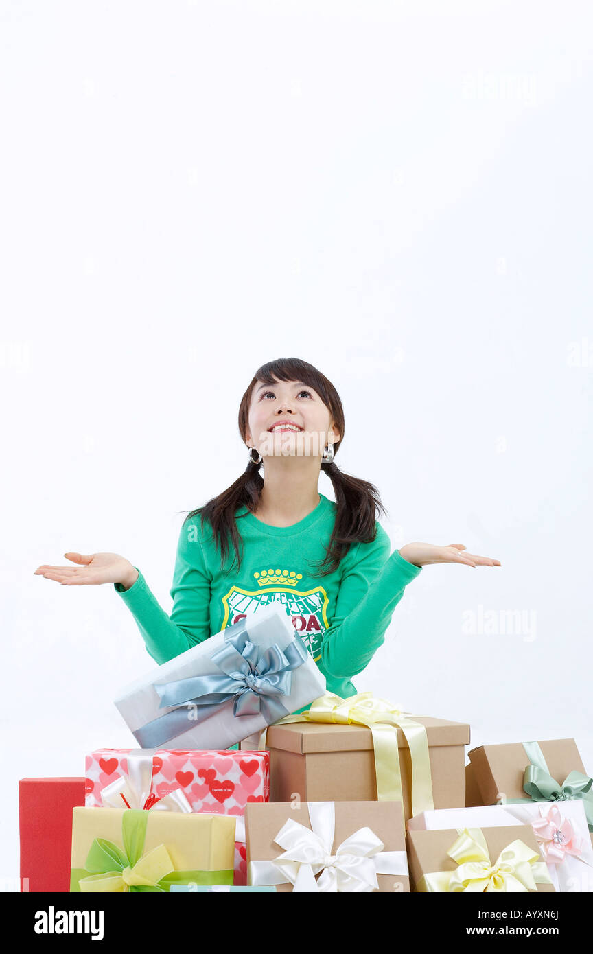 a woman being pleased looking at stack of gift case Stock Photo - Alamy