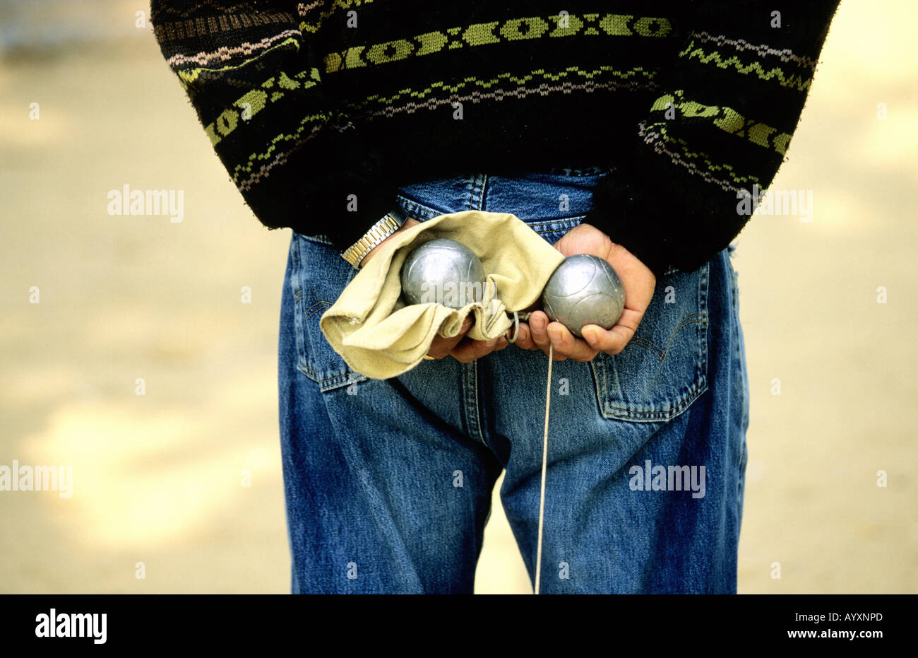 frenchman holding boules cradled in soft cloth behind his back with a ...