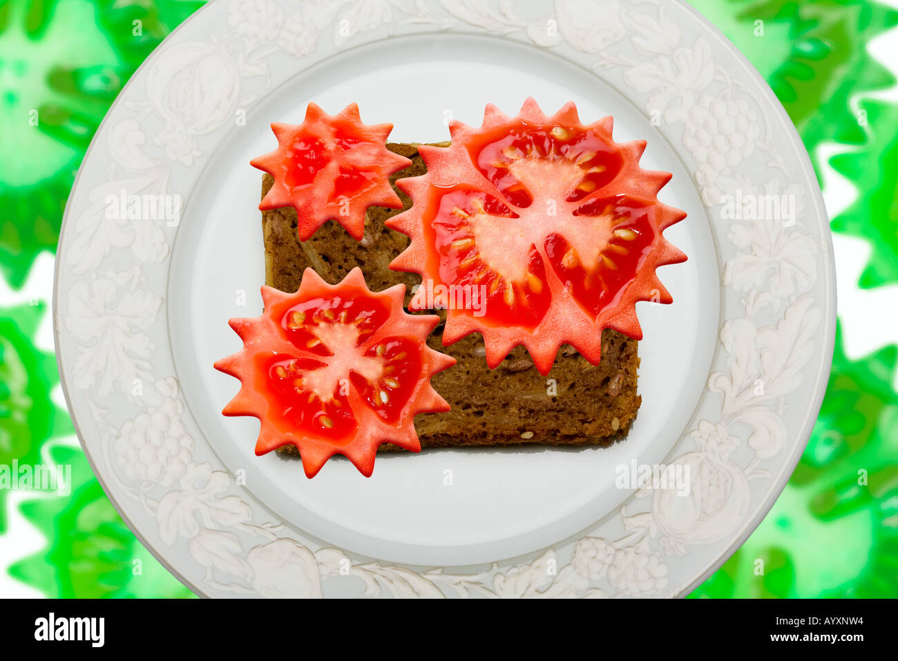 Tomato gear wheels on black bread Stock Photo - Alamy