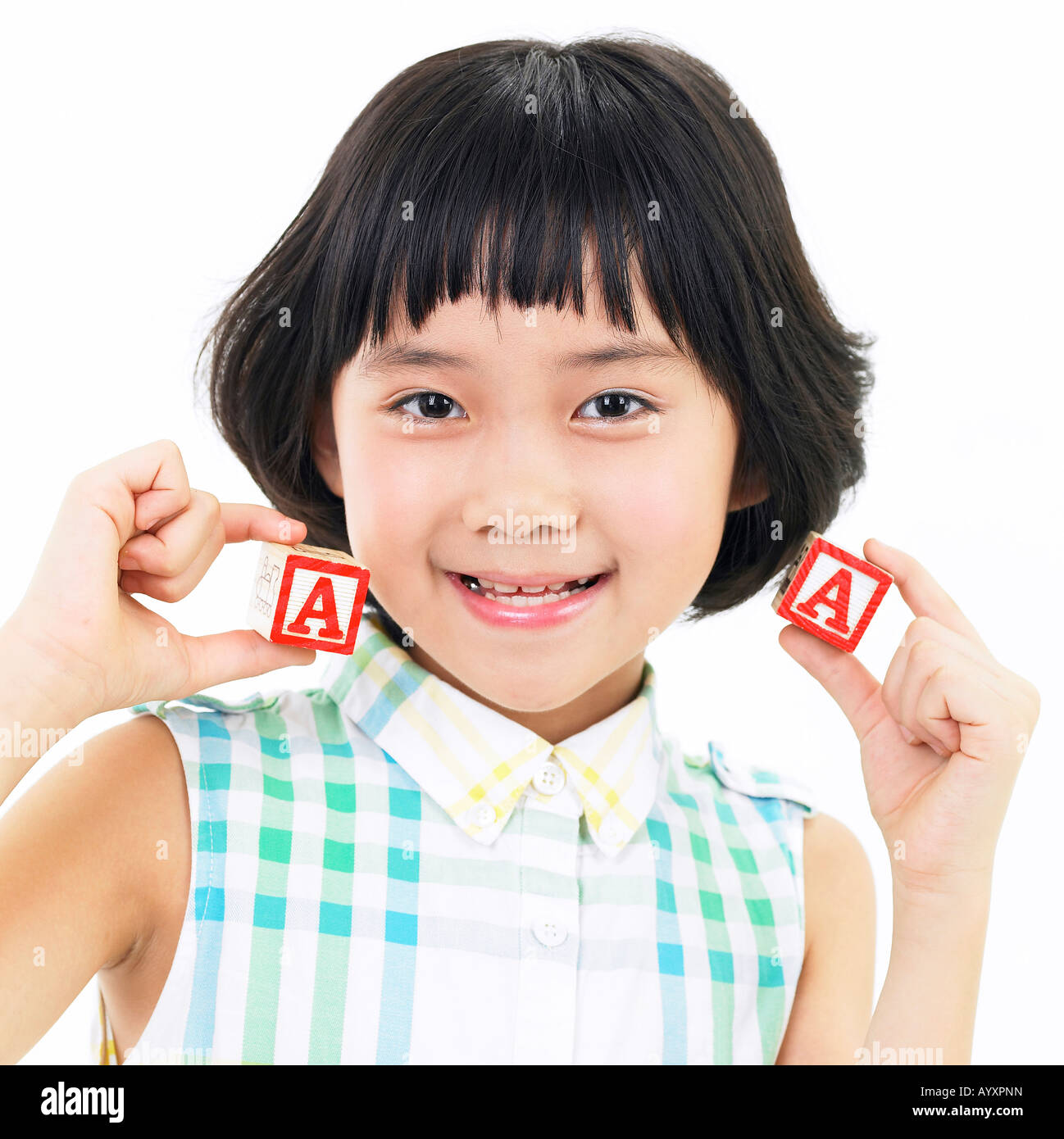 a girl holding alphabet block Stock Photo - Alamy