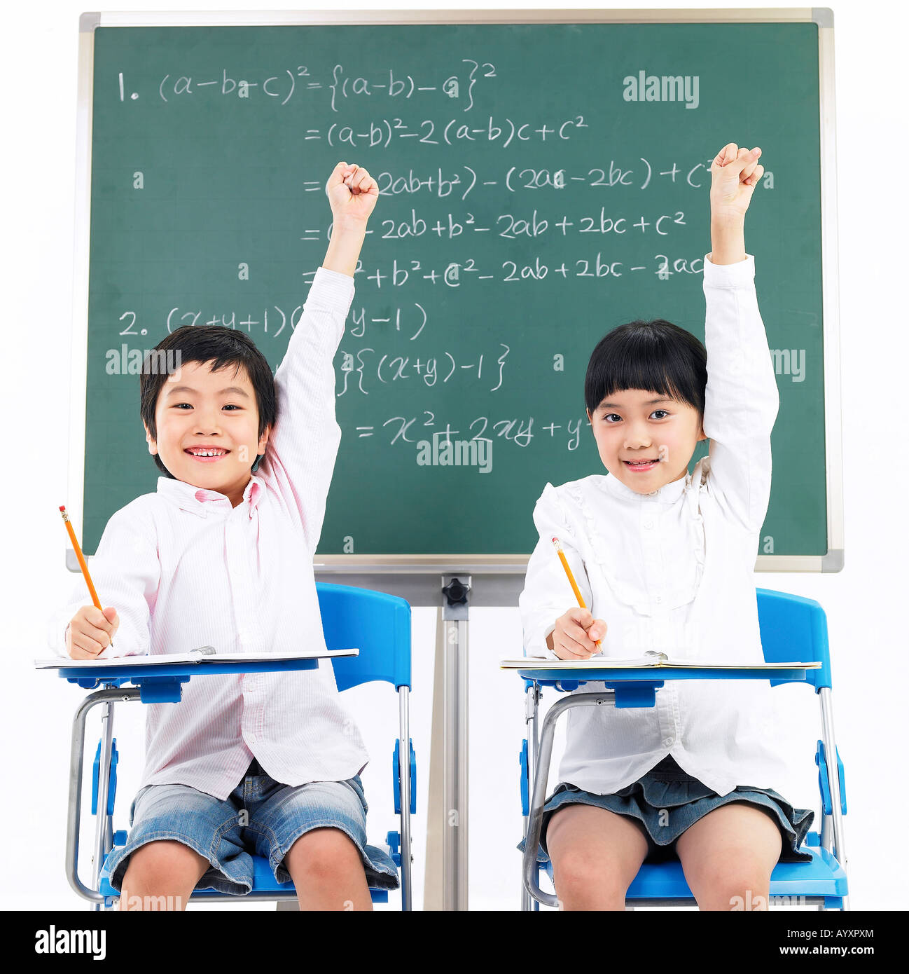 children presenting with sitting in front of board Stock Photo - Alamy