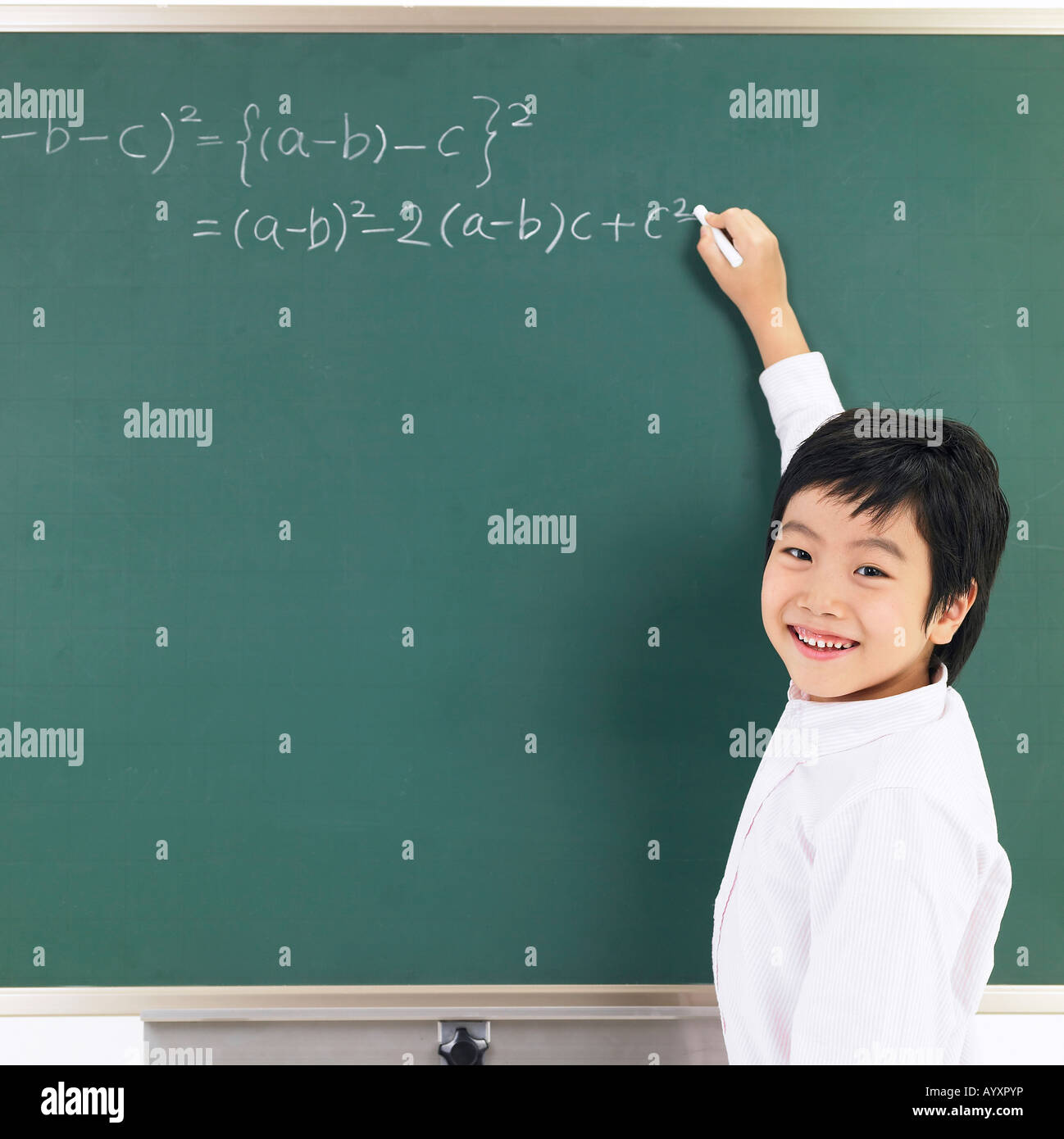 a boy resolving a question with standing in front of board Stock Photo ...