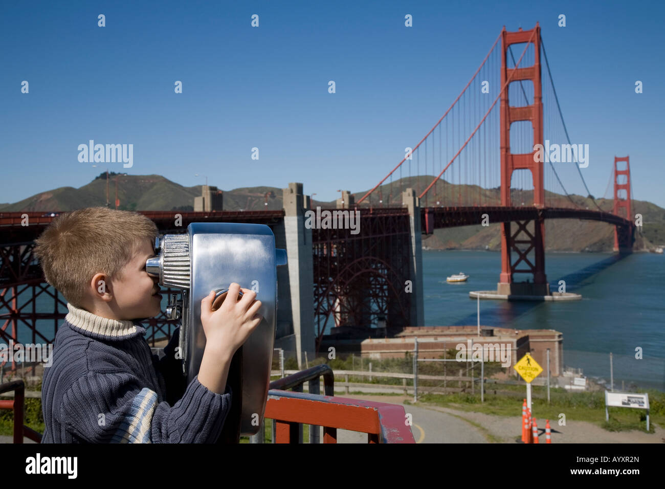 Boy using telescope in front of the Golden Gate Bridge Stock Photo - Alamy
