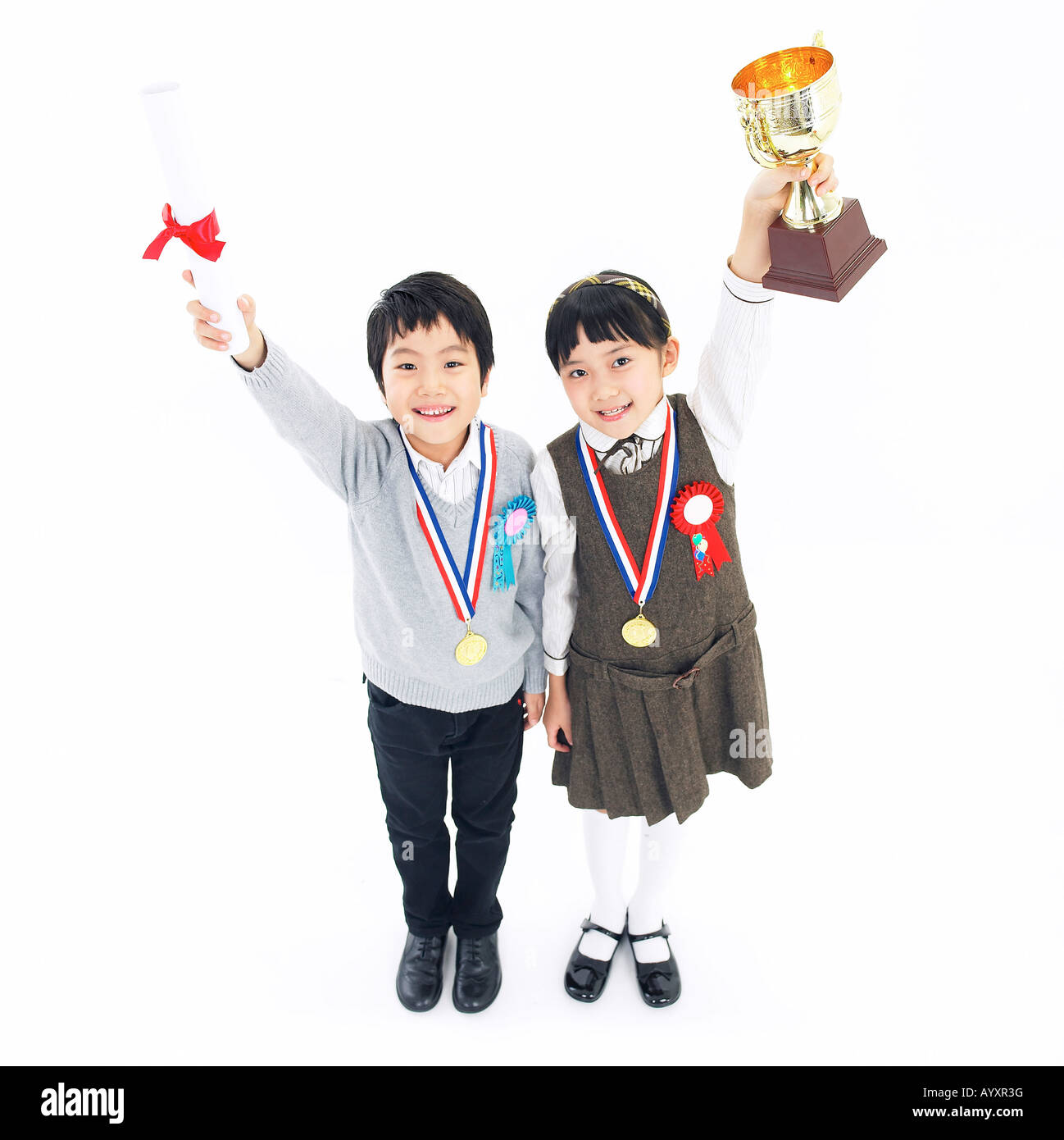 children holding a trophy and a testimonial Stock Photo - Alamy
