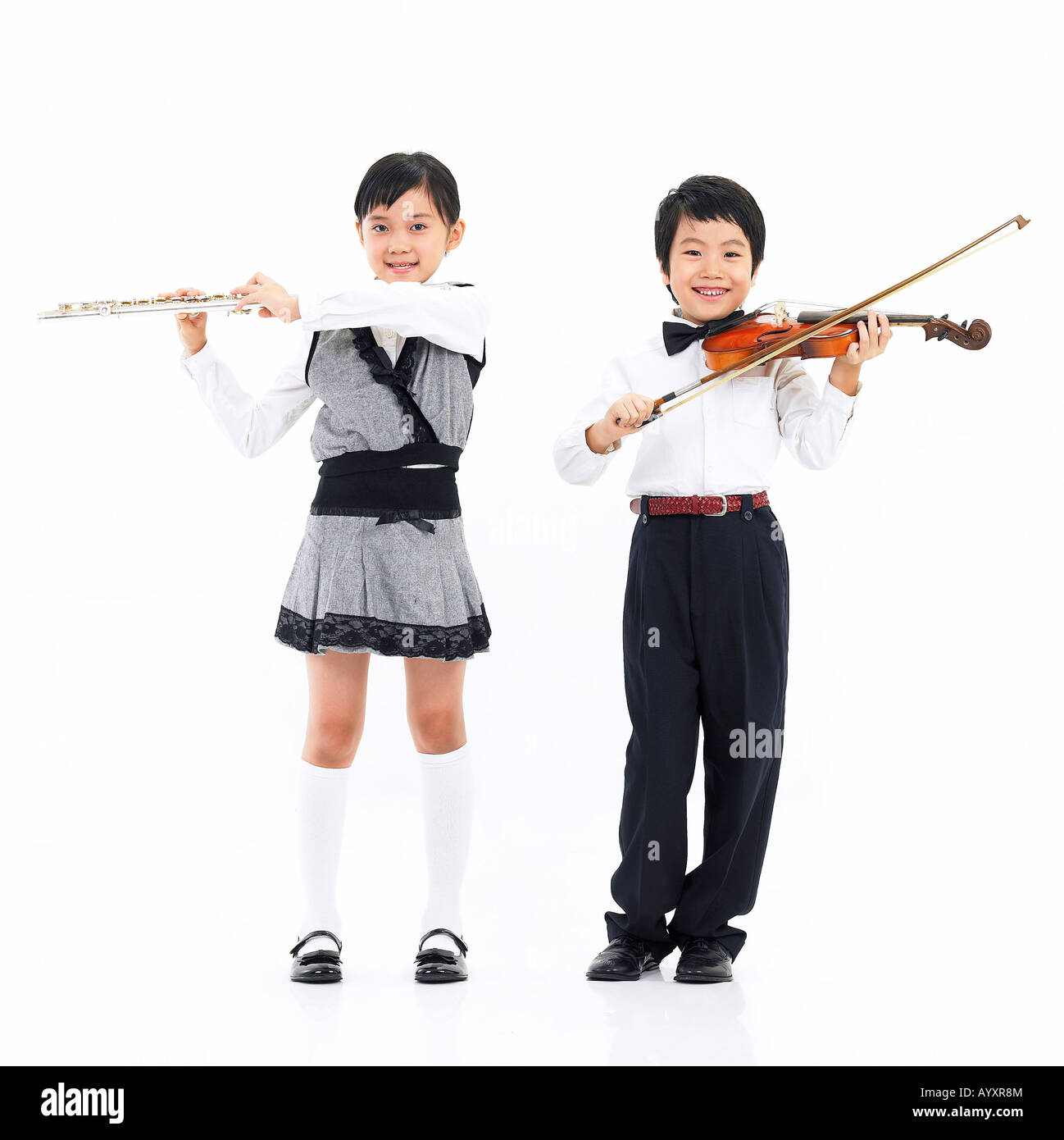 girl blowing flute and boy playing violin Stock Photo - Alamy