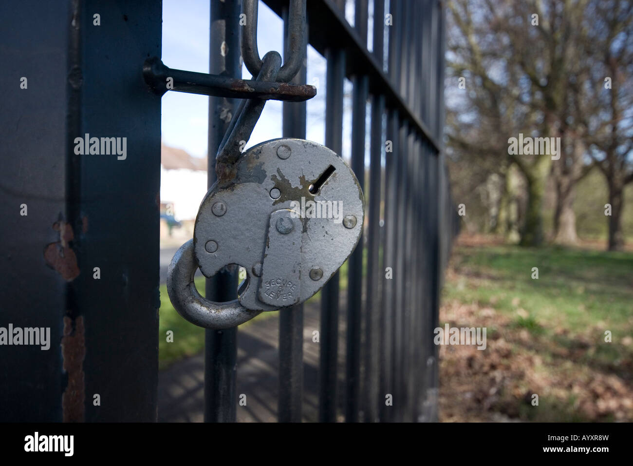 Padlock hanging from park gate, London England Stock Photo - Alamy