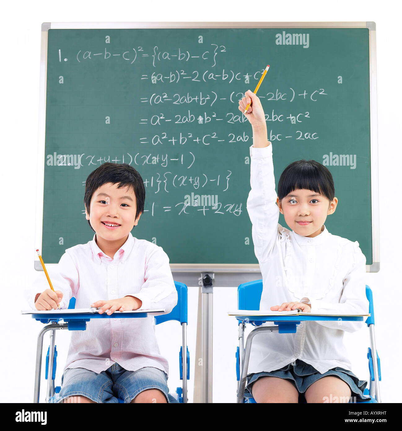 children presenting with sitting on in front of board and raising their ...