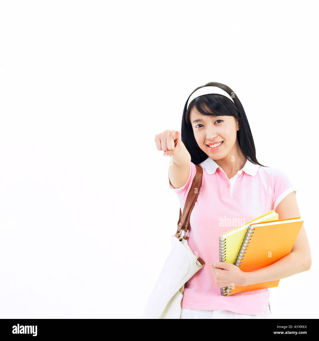 the girl pointing out the front with holding a book bag and a book ...