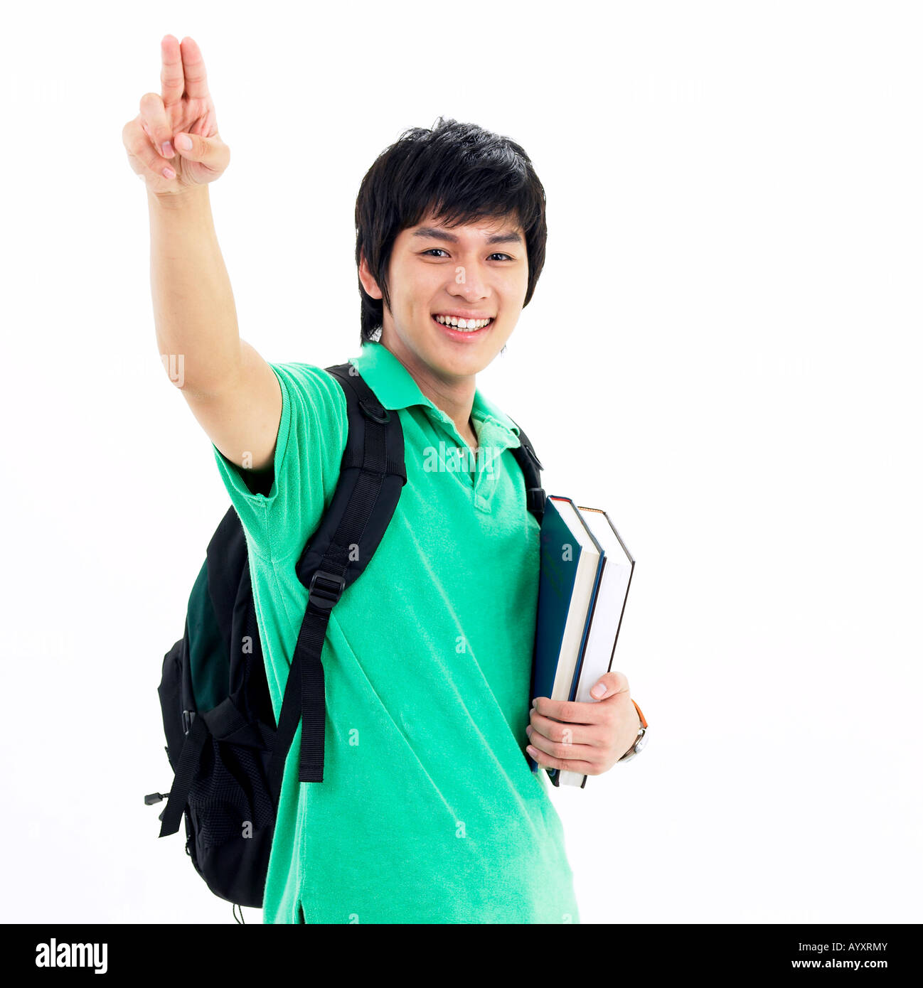 a boy raising his hand with holding a book bag and book Stock Photo - Alamy