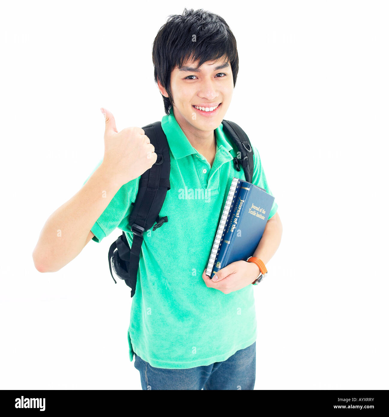 a boy student holding a book with thumb up Stock Photo - Alamy