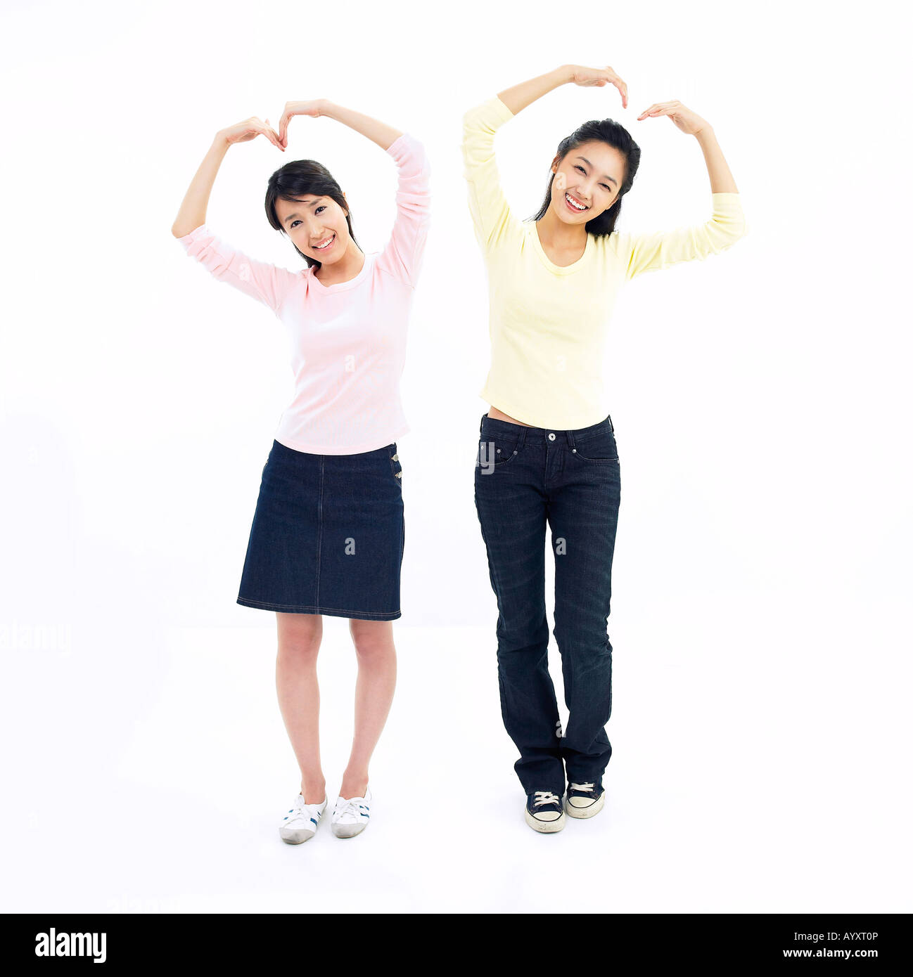 girl students standing with making a shape of heart by arms Stock Photo ...