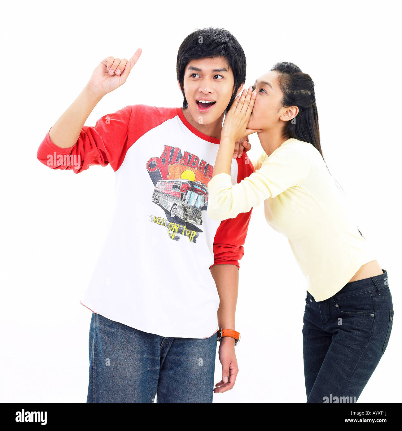 a girl student talking in a whisper to a boy student Stock Photo - Alamy