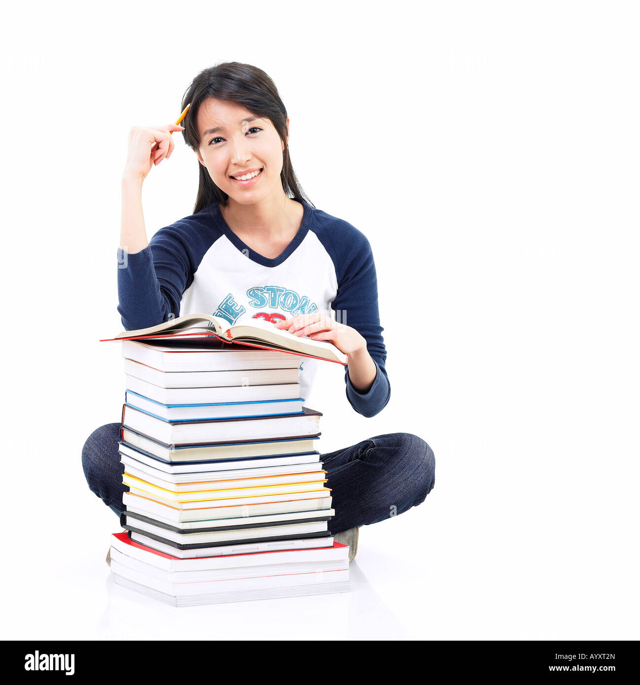 a girl studying on the stack of books Stock Photo - Alamy