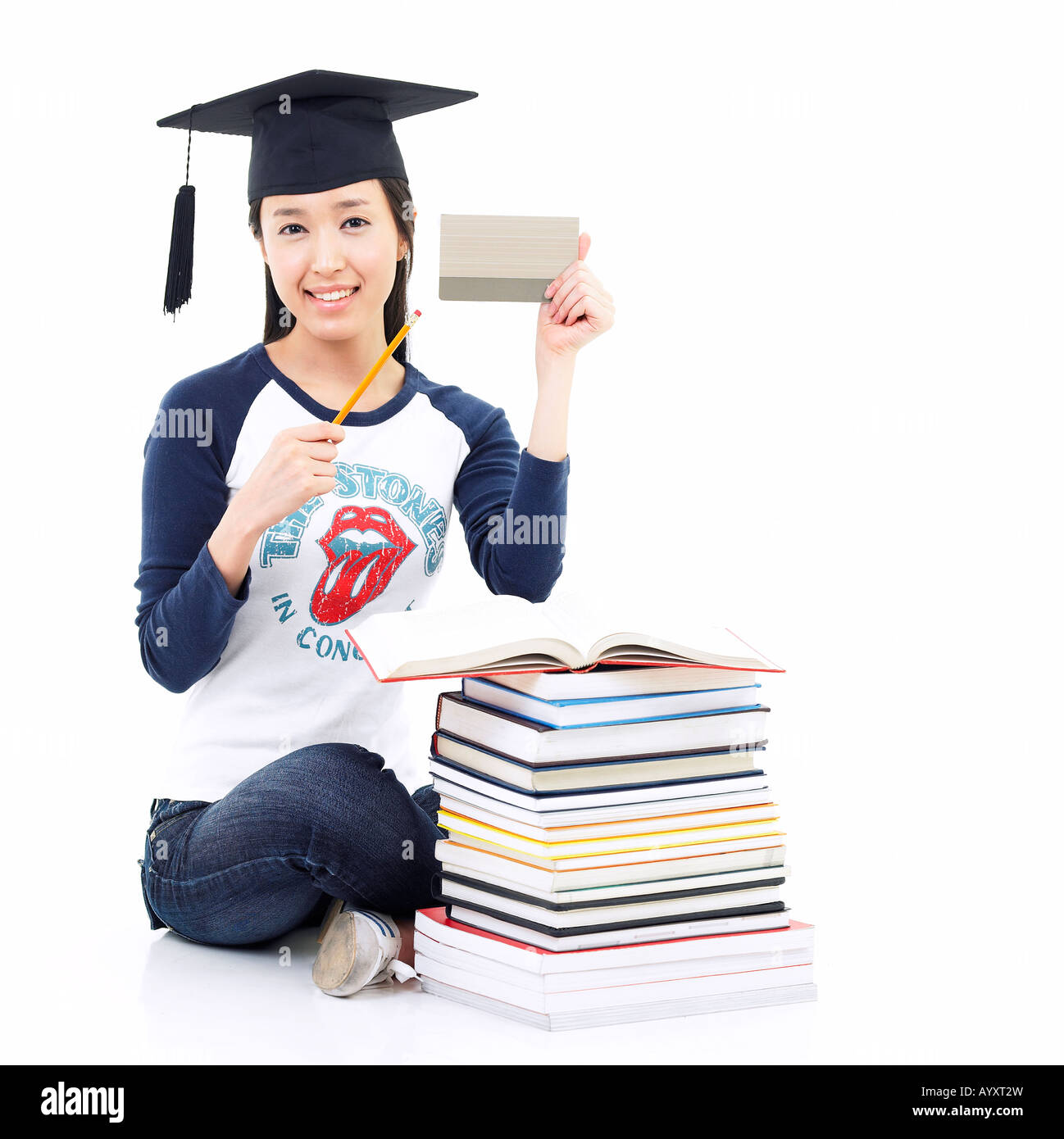 a girl studying on the stack of books Stock Photo - Alamy