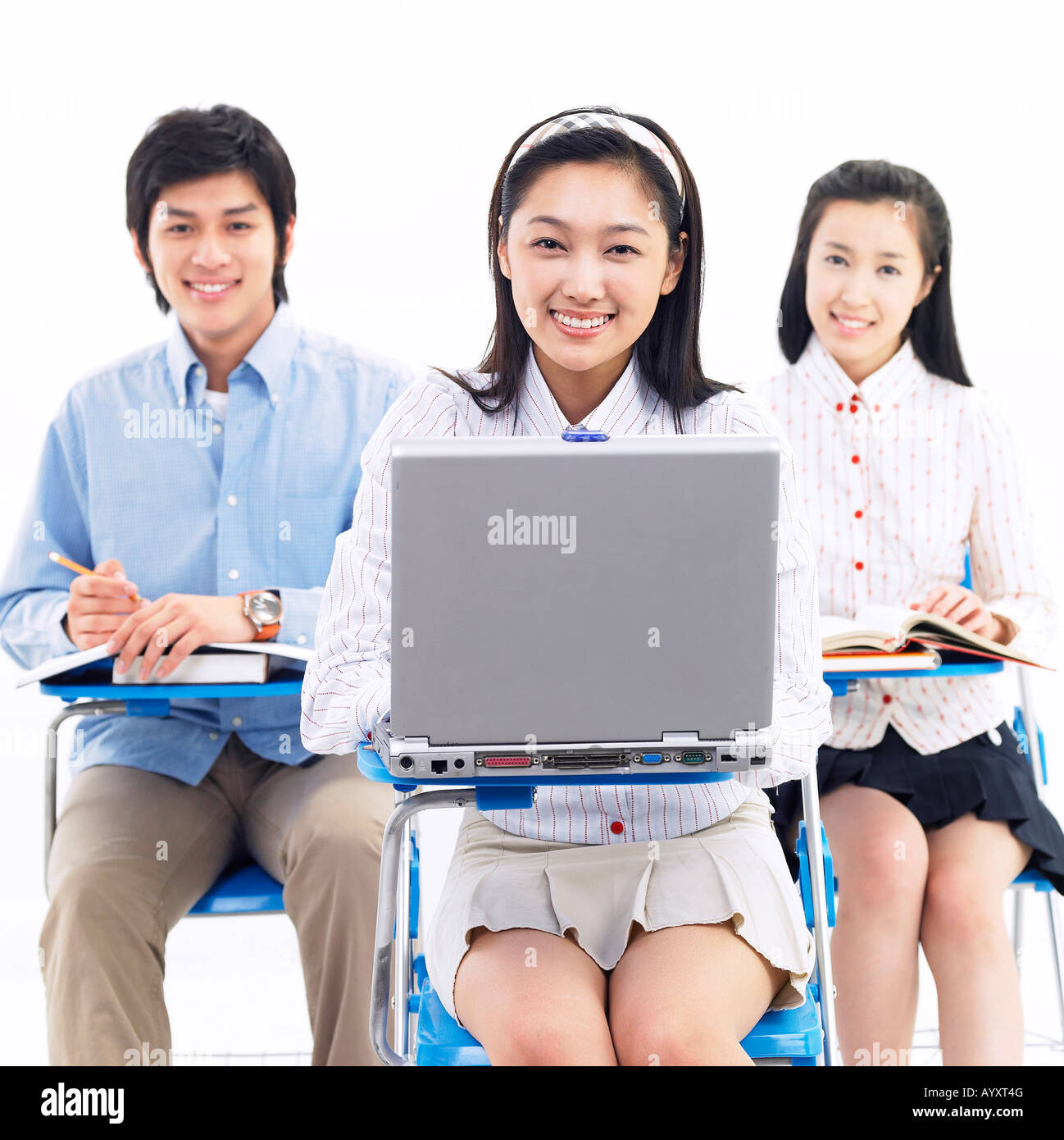 students sitting on desk with unfolding a laptop computer and book ...