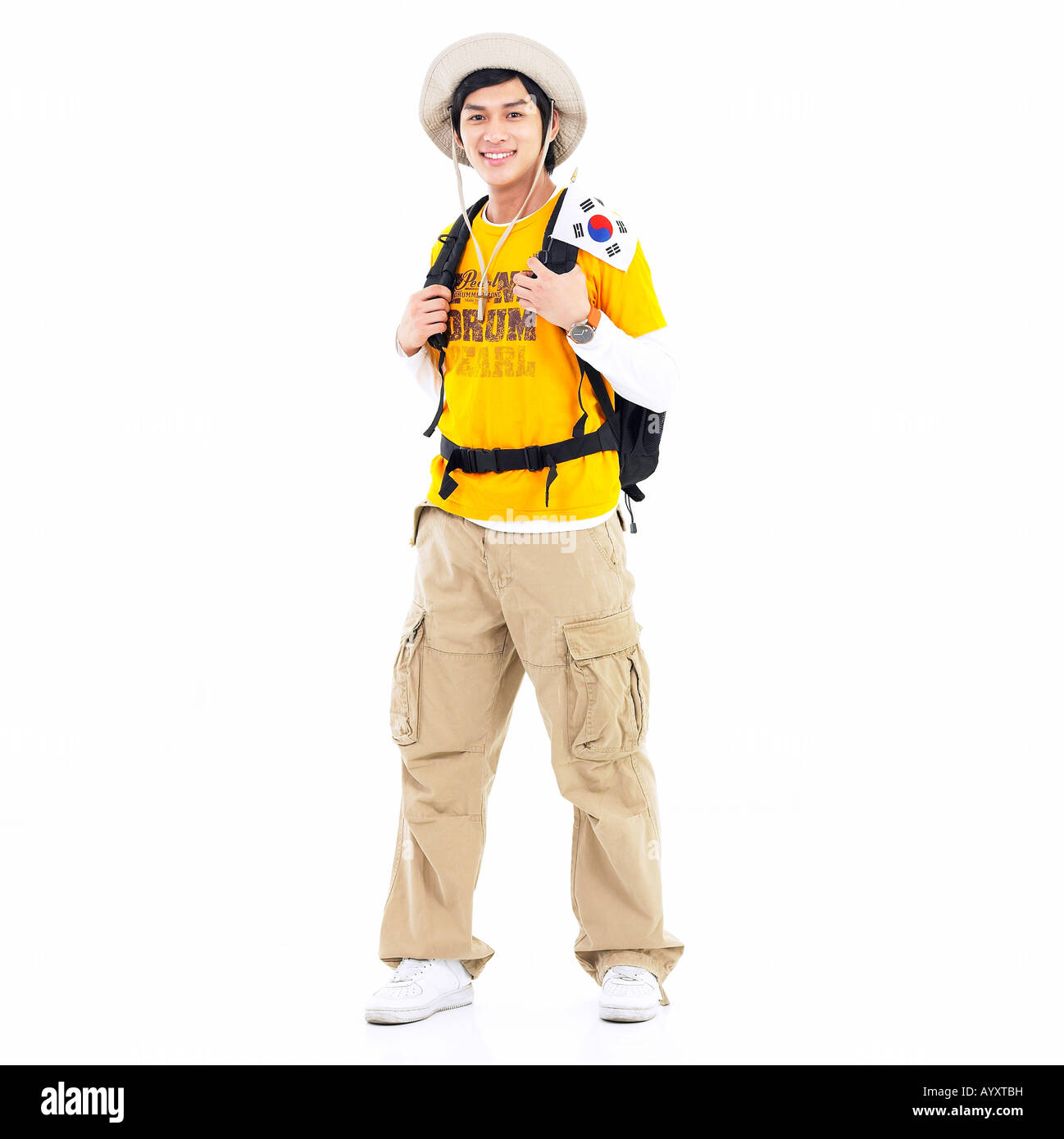 a boy student holding the national flag of Korea with carrying backpack ...