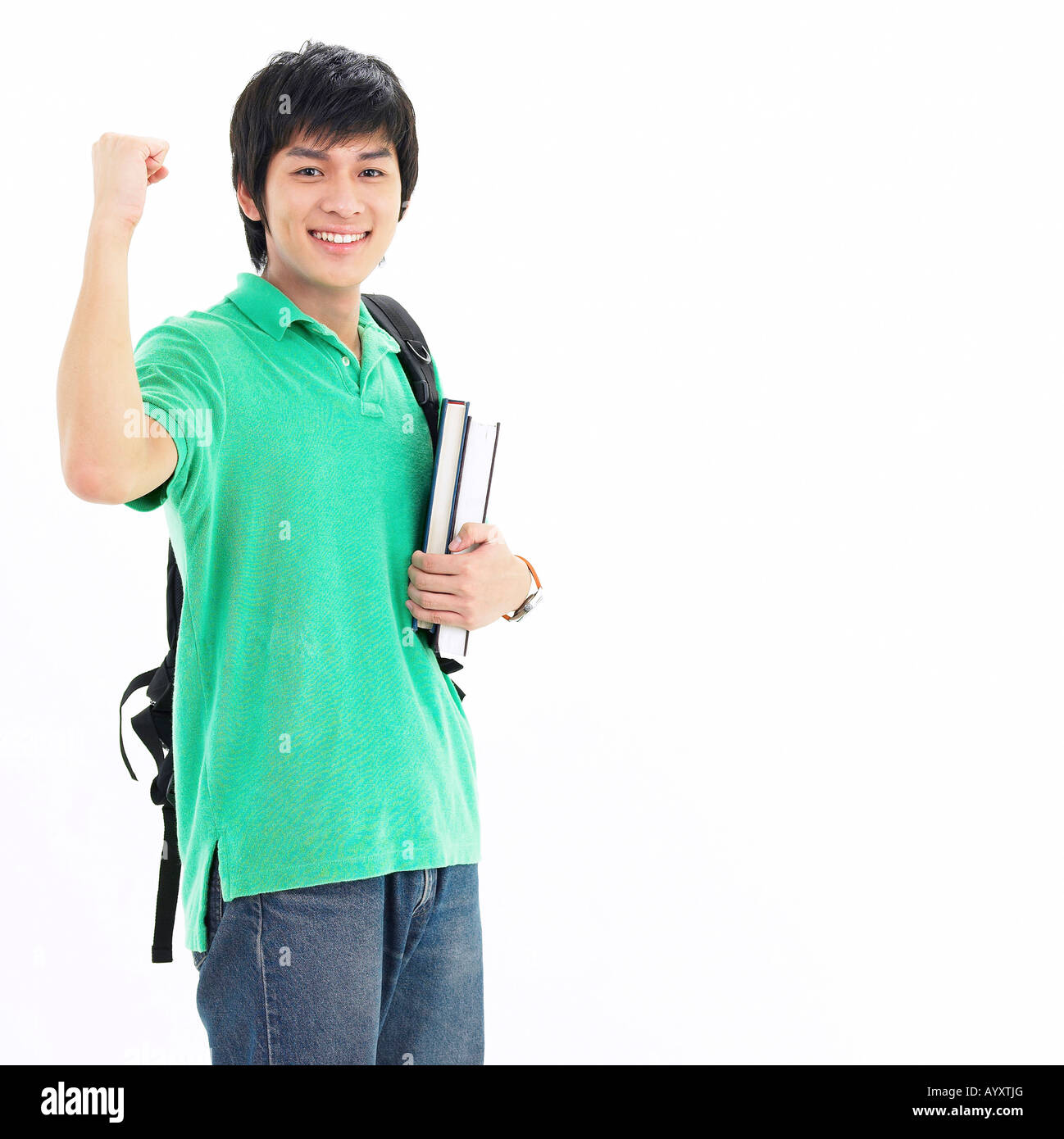 a boy student keeping it up with holding a book bag and book Stock ...
