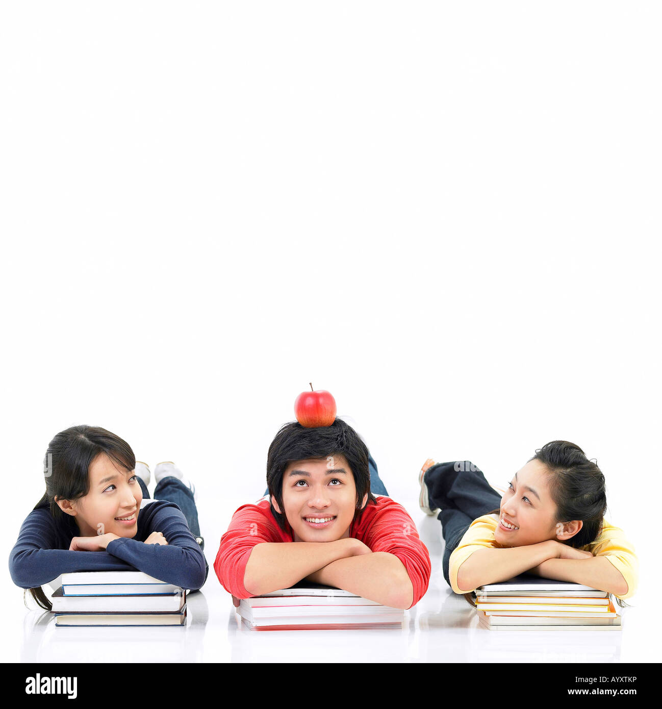 students laying down on the stack of books Stock Photo - Alamy