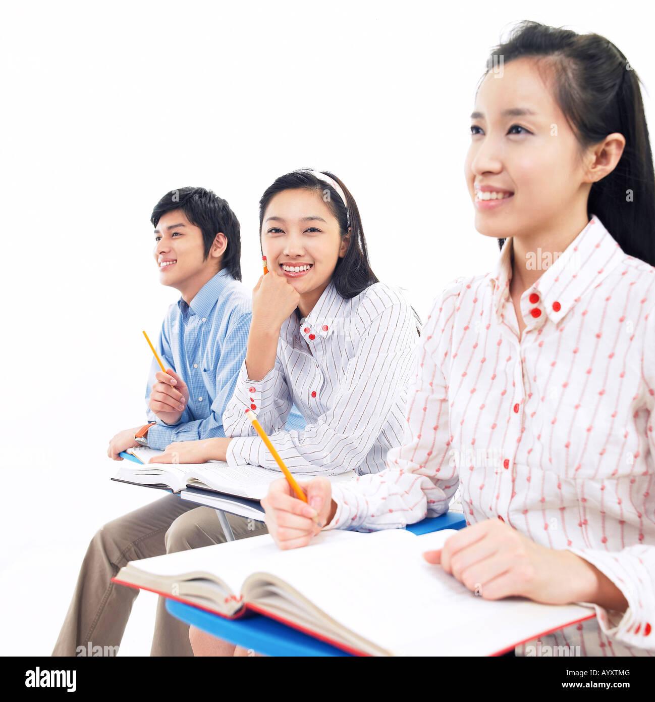 students studying with sitting on the desk Stock Photo - Alamy