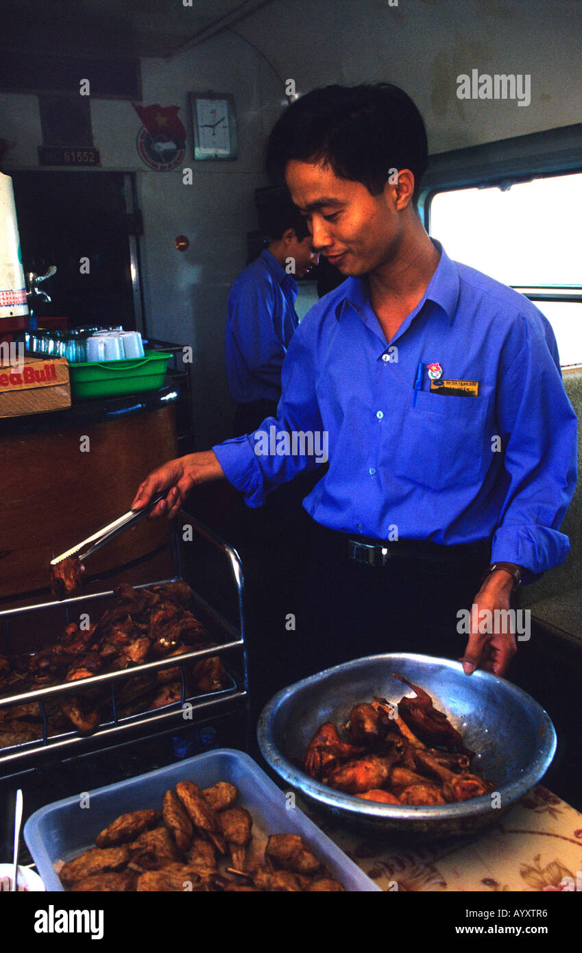 Waiter preparing food in the Reunification Express train, that runs ...