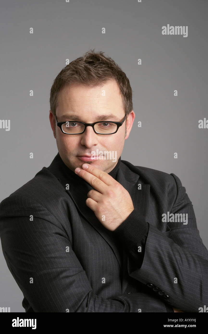 Man touching chin fingers hi-res stock photography and images - Alamy