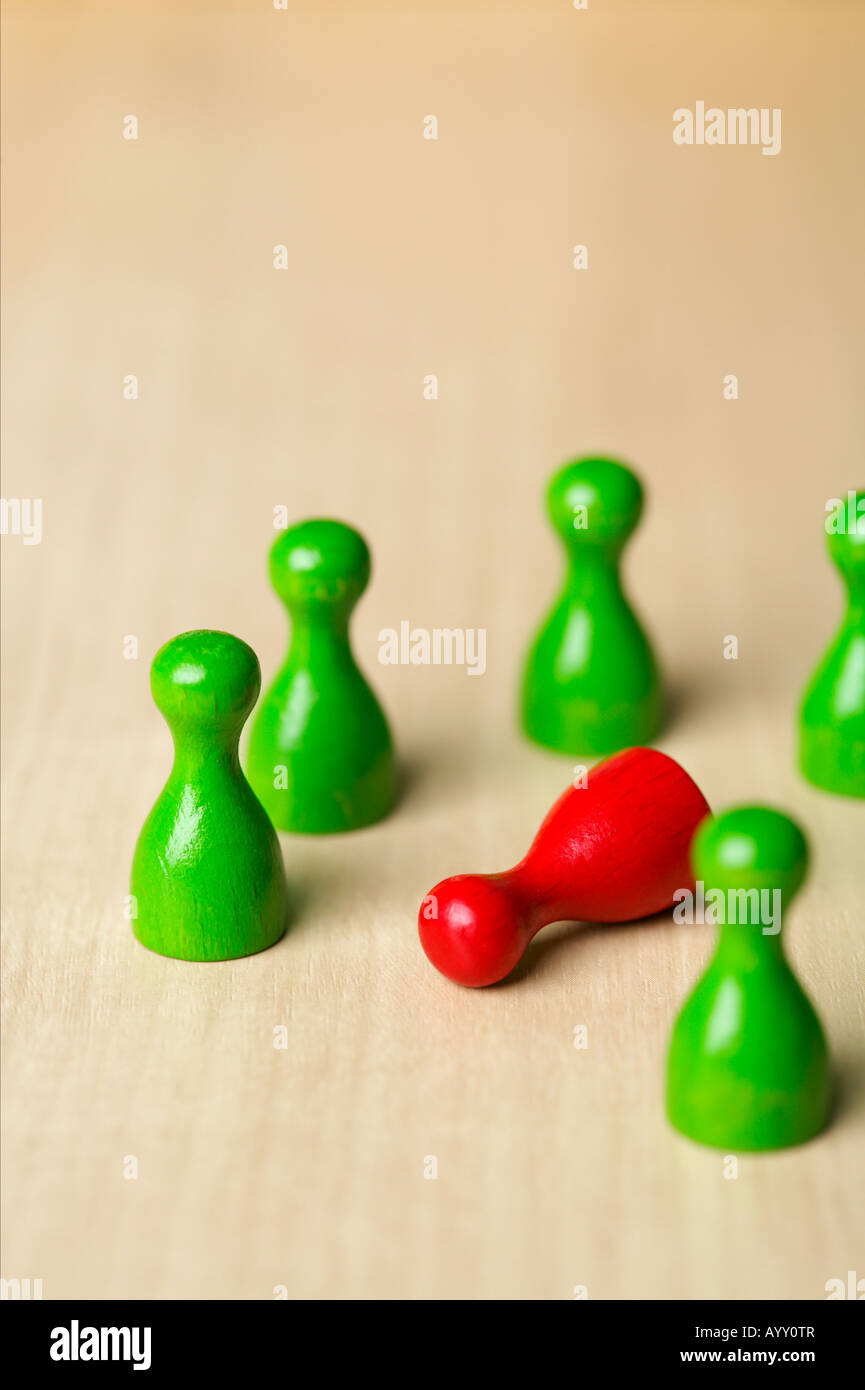 Red game piece lying between green ones Stock Photo - Alamy