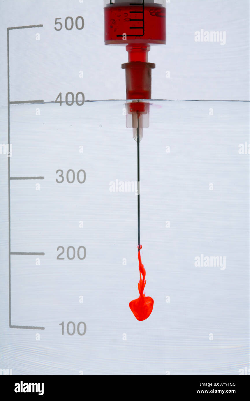 Injection of red liquid into water Stock Photo - Alamy