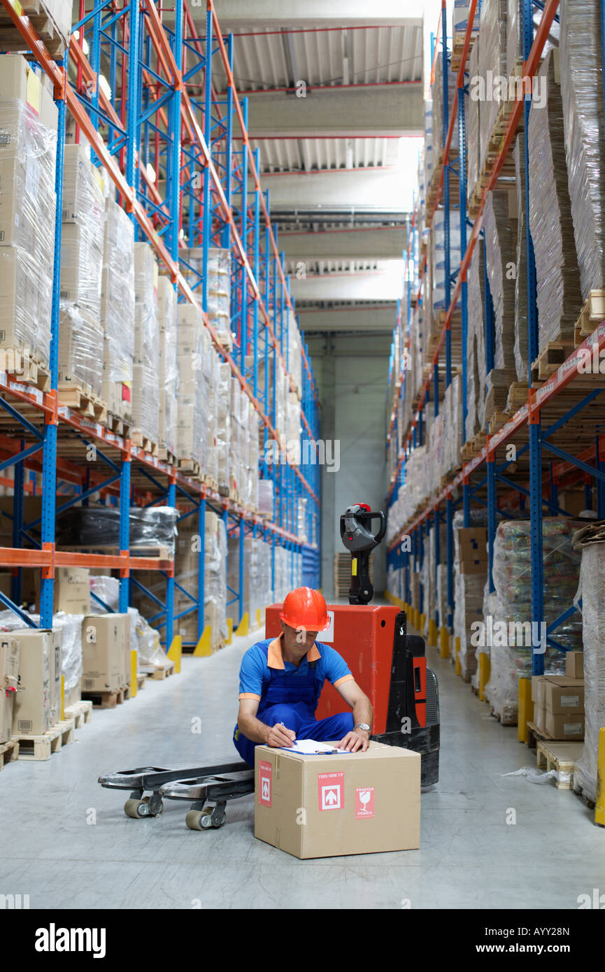 Person stooping and lifting box hi-res stock photography and images - Alamy