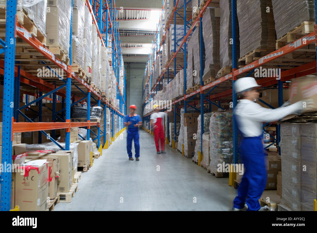 Three people in a warehouse Stock Photo - Alamy